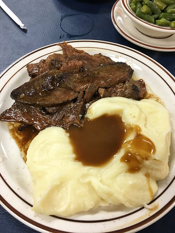 Roast beef that doesn't need a knife—just a gentle nudge and it surrenders, melting into those perfect mashed potatoes like old friends reuniting.