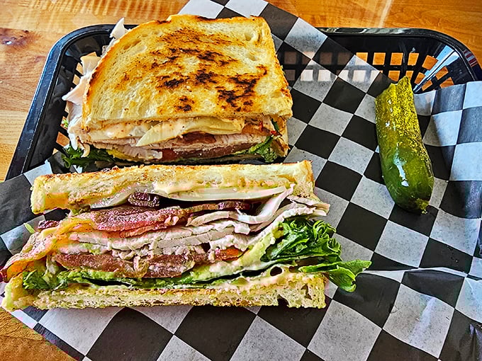 Two sandwiches, one pickle, infinite satisfaction. The perfectly grilled bread houses layers of goodness that would make any deli proud.