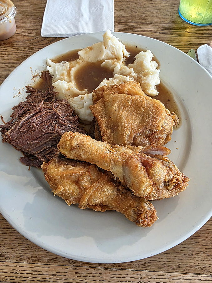 The holy trinity of comfort: roast beef, fried chicken, and cloud-like mashed potatoes. This plate doesn't need Instagram filters—it's naturally photogenic.