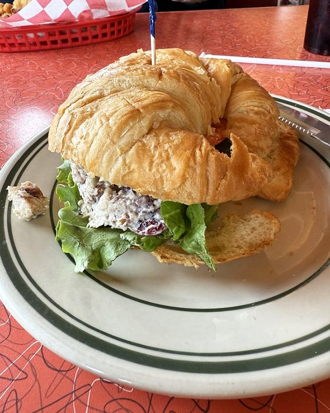 This croissant sandwich isn't just lunch – it's edible engineering, with layers of chicken salad and crisp lettuce creating perfect harmony.