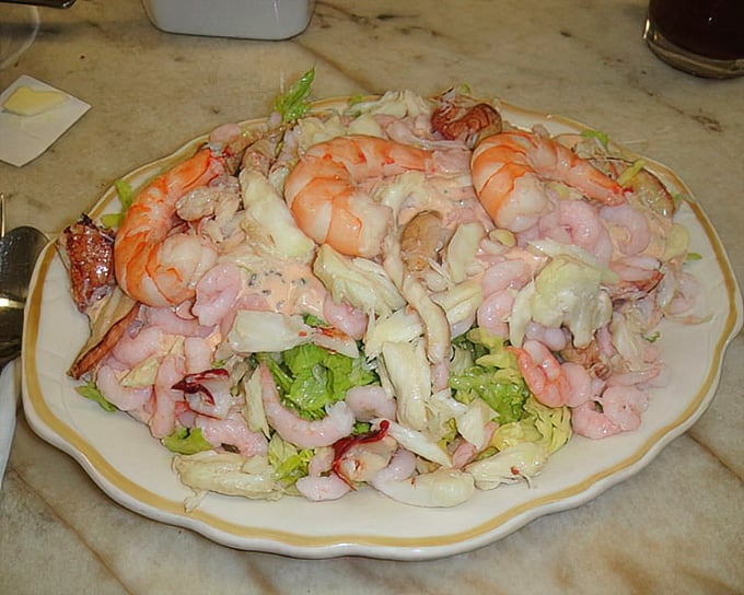 The seafood salad that launched a thousand road trips – where shrimp, crab, and friends throw the perfect party.