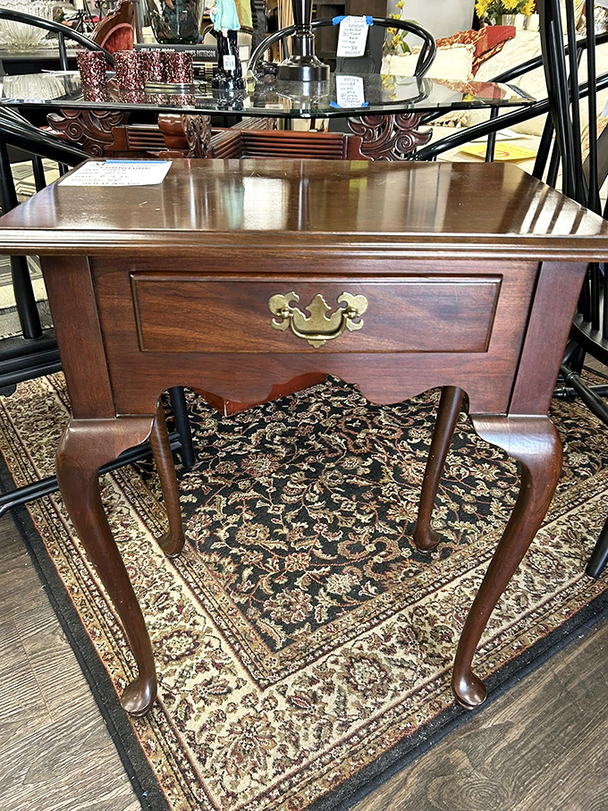 Queen Anne legs and brass hardware—this side table has seen more history than most history books. Elegant craftsmanship awaits its next chapter.
