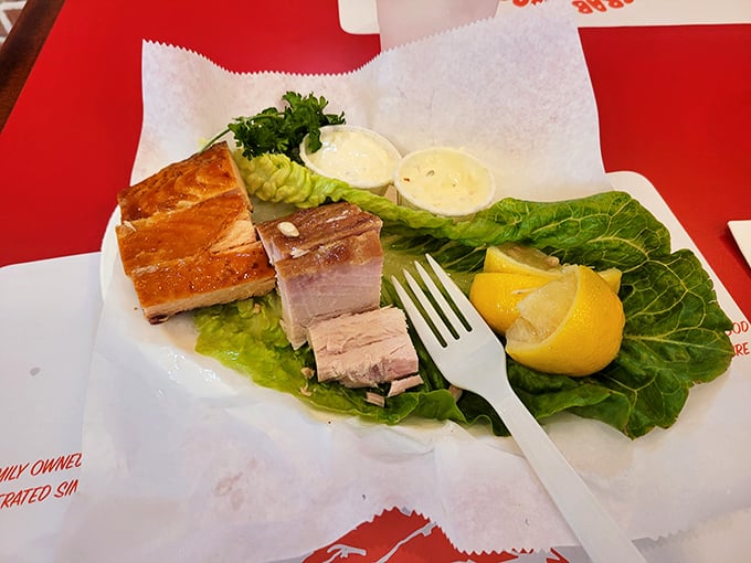 Smoked fish presented with the reverence it deserves—on a bed of greens with lemon wedges standing by for their supporting role.