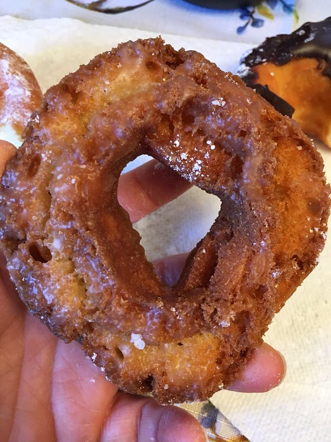 This isn't just fried dough—it's an engineering marvel of crispy exterior yielding to pillowy interior, glistening with a glaze that reflects your delighted expression.