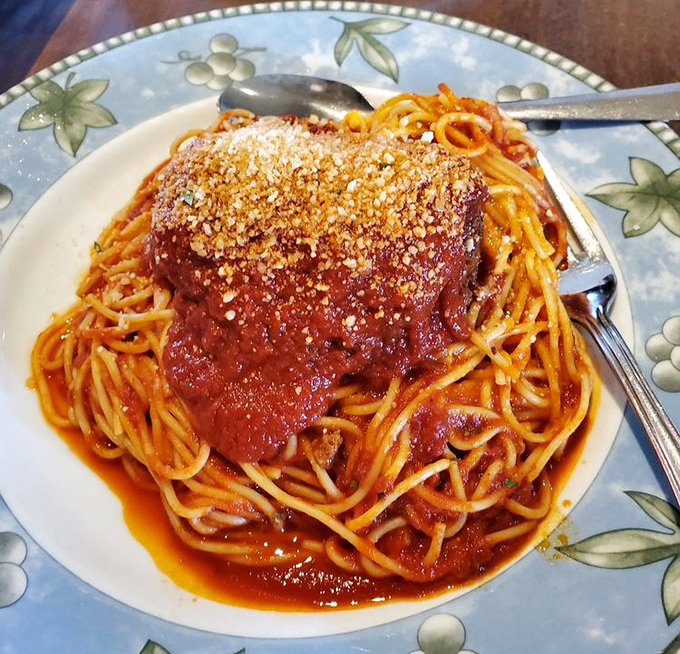The spaghetti and meatball isn't just a dish—it's a monument to Italian-American cuisine, crowned with a parmesan snowcap.