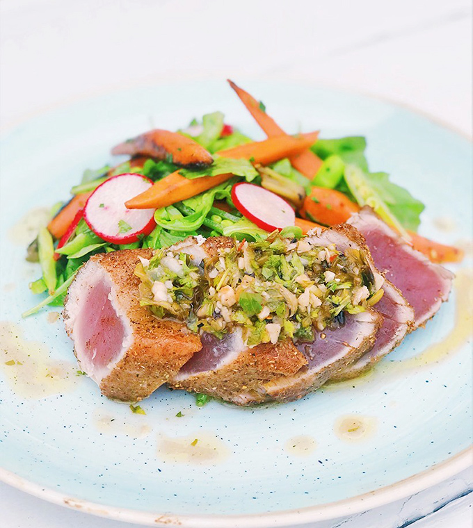 Seared tuna that's dressed better than most people at a wedding—pink in the middle with a garden-fresh salad that's more than just a pretty face.