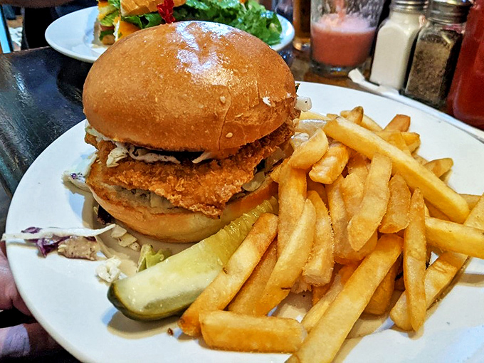 Not your average chicken sandwich—this crispy creation with golden fries might just make you postpone dinner plans indefinitely.