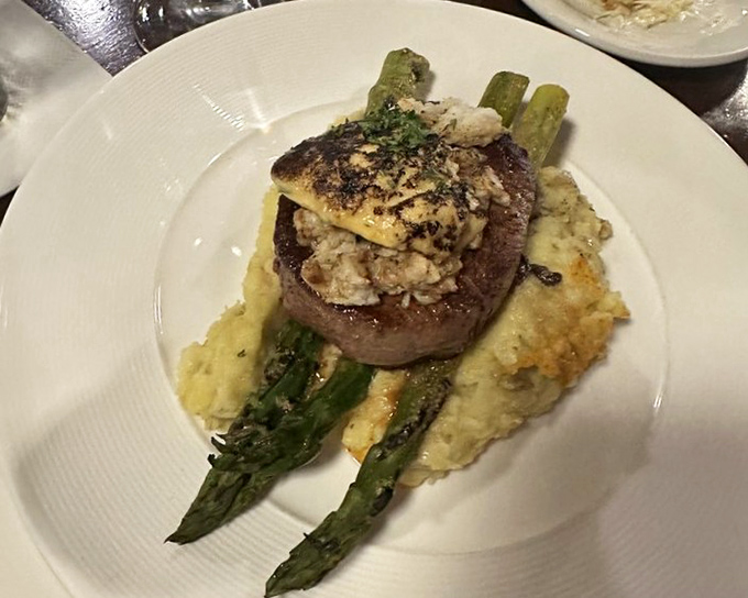 Steak Oscar – where land meets sea in perfect harmony. That filet mignon looks like it's wearing its Sunday best with crab and asparagus.