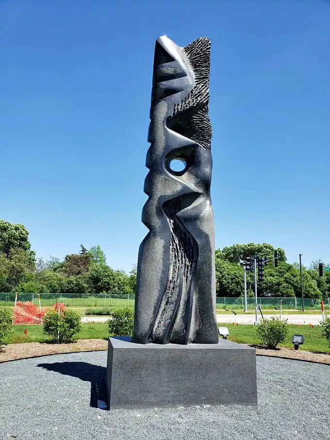 Modern meets ancient in this outdoor sculpture. Like a sentinel guarding treasure, it hints at the artistic marvels waiting inside.