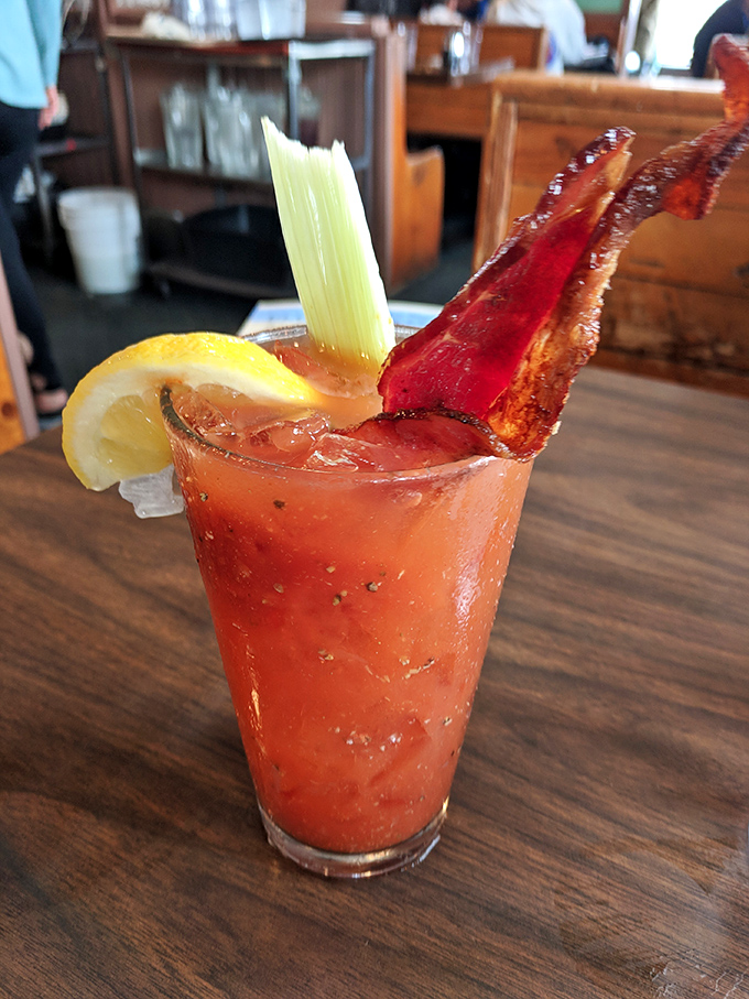 The Stove's Bloody Mary comes with its own breakfast—a strip of bacon that's both garnish and appetizer. Genius multitasking.