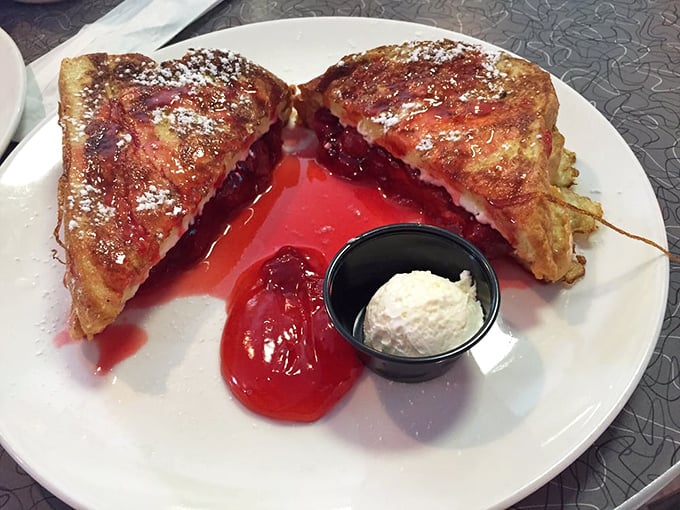 Stuffed French toast that bleeds strawberry goodness—it's breakfast masquerading as dessert, and nobody's complaining. The whipped cream is just showing off.