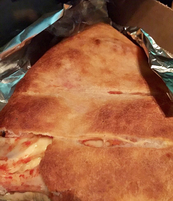 This golden-brown creation looks like it was kissed by the sun—crispy exterior giving way to a steamy, cheese-filled interior.