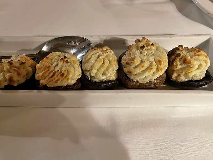 Stuffed mushrooms lined up like edible soldiers, their creamy tops golden-brown and ready to launch a delicious assault on your taste buds.