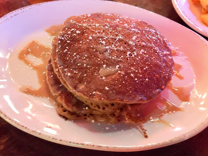 Sweet potato pancakes drizzled with syrup and dusted with powdered sugar—like autumn decided to throw itself a party on a plate.