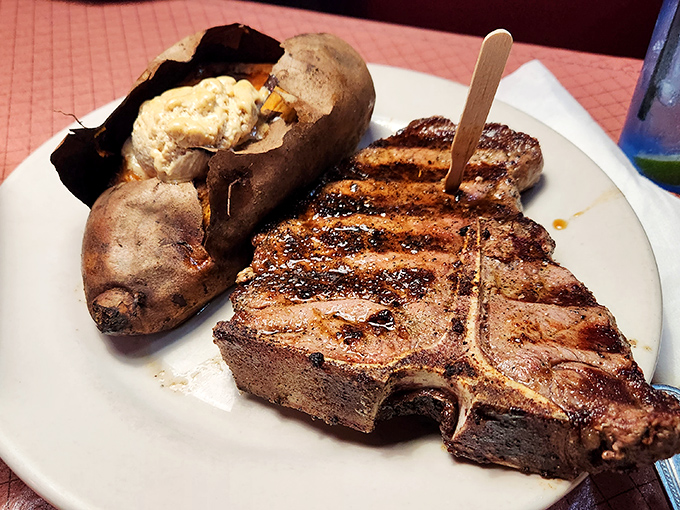 This T-bone doesn't just share a plate with a baked potato—they're having a full-blown flavor summit meeting.