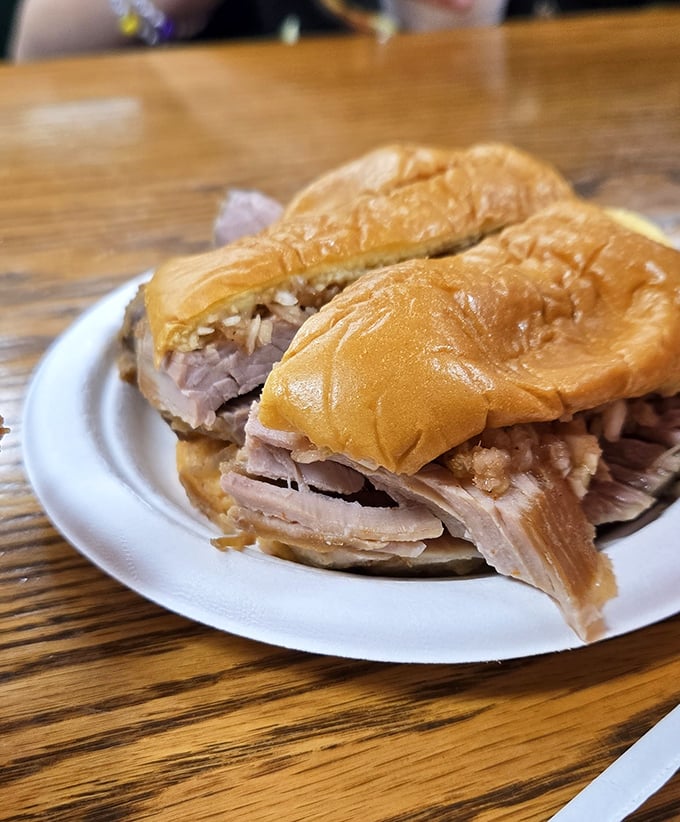 The sliced sandwich—where each piece of pork tells its own nine-hour smoke story between two perfectly ordinary buns.