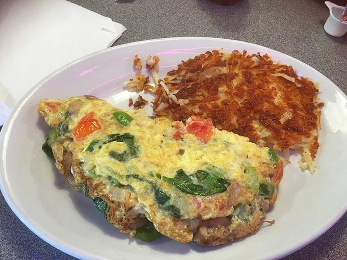 This veggie omelet proves vegetables can be more than just healthy—they can be downright indulgent when folded into fluffy eggs alongside those golden hash browns.