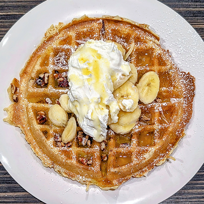This banana-pecan waffle isn't just breakfast—it's therapy with maple syrup. The whipped cream is just showing off.