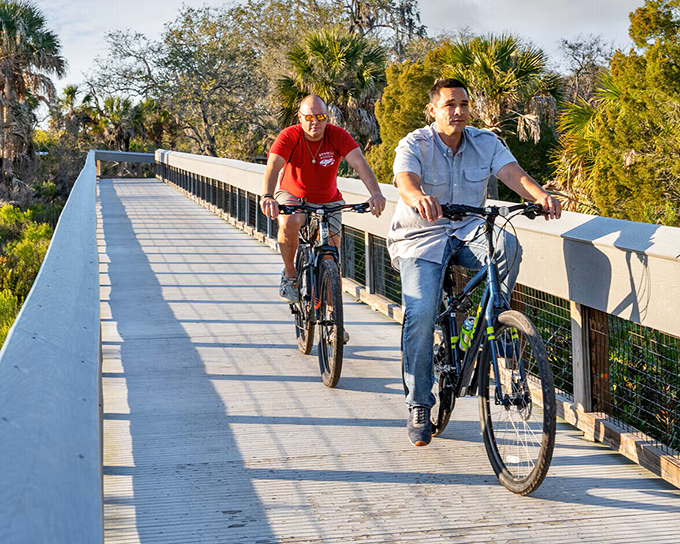 Two cyclists enjoying the boardwalk at Werner-Boyce Salt Springs State Park – nature's treadmill with infinitely better scenery.