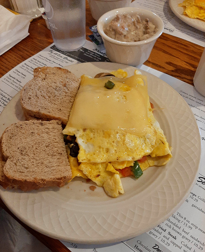 This isn't just breakfast—it's morning salvation. Cheese blankets eggs and vegetables in a harmony that makes waking up worthwhile.