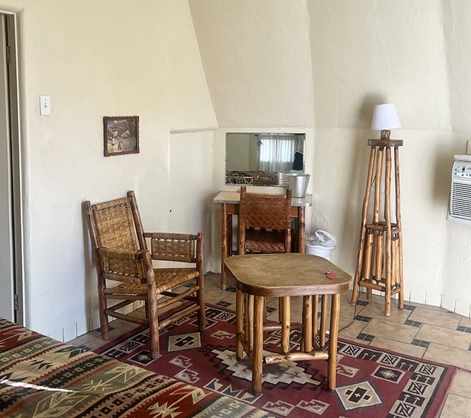 Rustic wooden furniture and geometric rugs transform your teepee into a surprisingly sophisticated southwestern retreat.