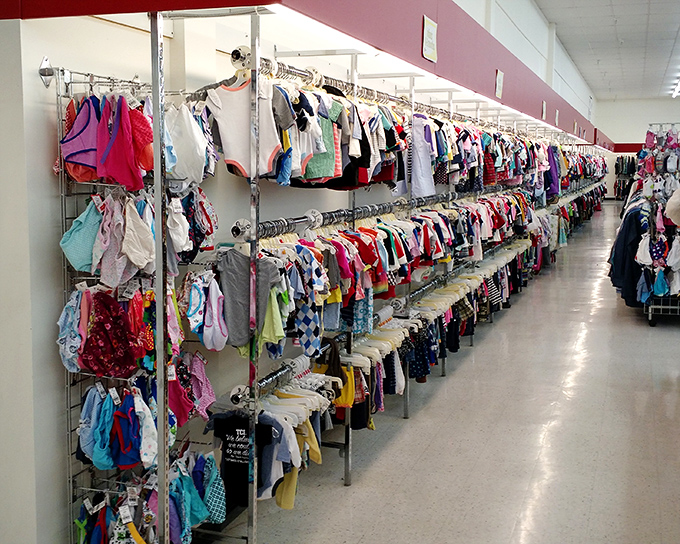 Tiny clothes for tiny humans, all meticulously organized—unlike the actual rooms of the children who'll wear them. P