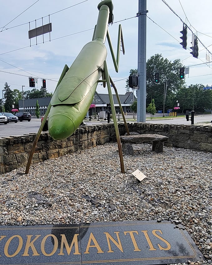 From behind, KokoMantis reveals its impressive engineering—seventeen feet of metal mantis balanced perfectly on stone, defying both gravity and convention.