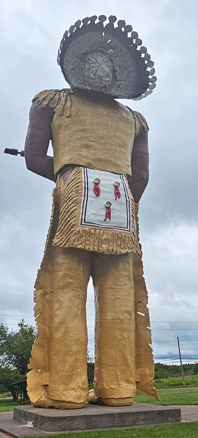 The back view reveals Hiawatha's impressive headdress—each feather the size of a kayak paddle, meticulously crafted in fiberglass.