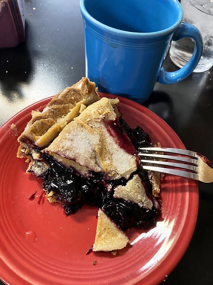 This black raspberry pie isn't just dessert; it's a purple-hued reminder that the best things in life require a fork and napkin.