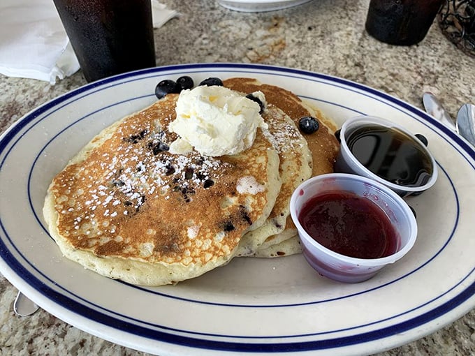 Blueberry pancakes that don't just carry the restaurant's name—they earn it. Fluffy discs dotted with berries and topped with a cloud of whipped cream.