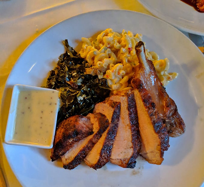 This bone-in pork chop arrives like a medieval feast designed for modern appetites and refined palates.