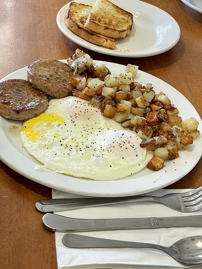 A breakfast plate that means business – eggs, sausage, and those golden potatoes that somehow taste like Sunday mornings.