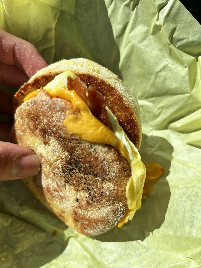 The breakfast sandwich—portable perfection between English muffin bookends. That melty cheese is performing gravity-defying feats worthy of a Vegas show.