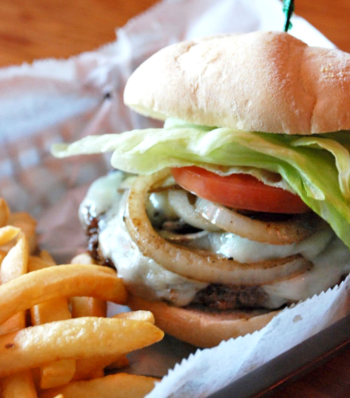 This isn't just a burger; it's architecture – layers of beef, cheese, and fresh toppings creating the skyscraper of satisfaction your appetite craves.