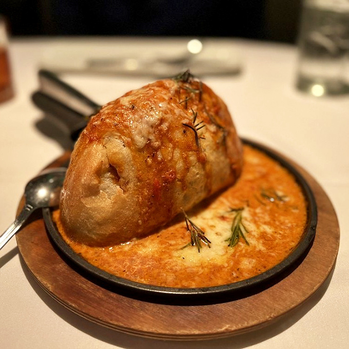 Not just bread—a soufflé masquerading as bread, swimming in a pool of creamy sauce that makes you question all other carbohydrates you've ever known.