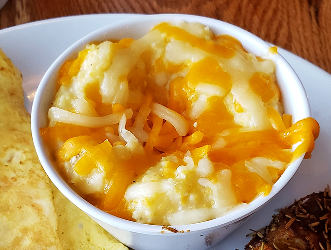 Cheese grits that would make a Southerner weep with joy – creamy, indulgent, and unapologetically comforting in their little white bowl of happiness.