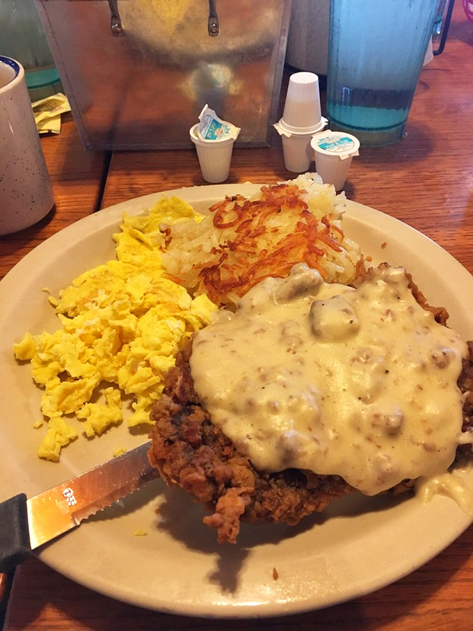 Country fried steak swimming in peppery gravy with hash browns and eggs—the breakfast of champions who plan on napping by noon.