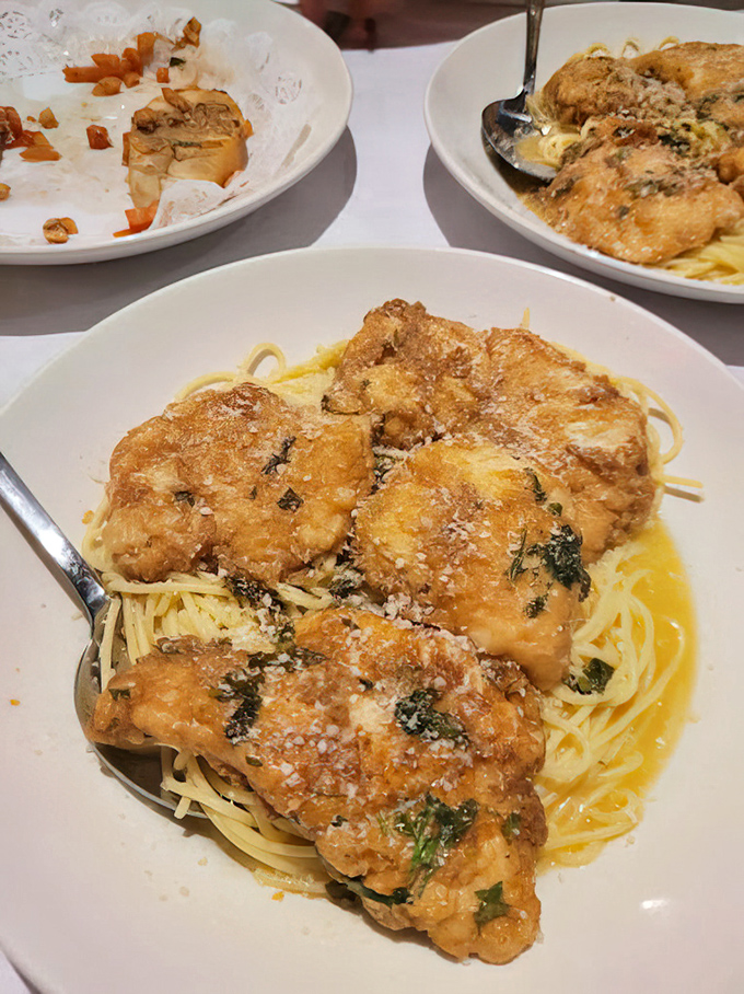 Golden chicken marsala lounging on a bed of pasta, basking in buttery sauce—like a sunbather who found the perfect spot on an Italian beach.