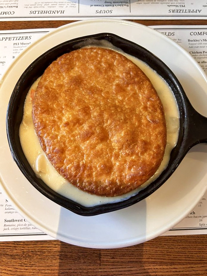 Behold the chicken pot pie—a golden dome of pastry floating atop a sea of creamy goodness that would make your grandmother simultaneously proud and jealous.