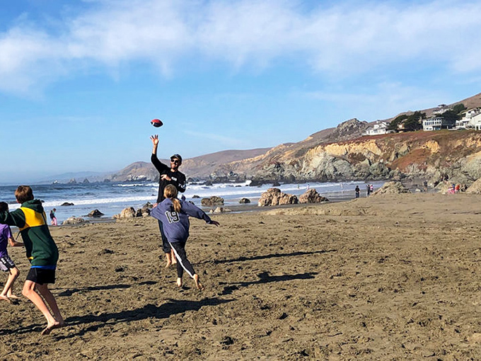 Football on the beach—where dropped passes are forgiven and sandy high-fives are mandatory. Weekend warriors finding their playground.