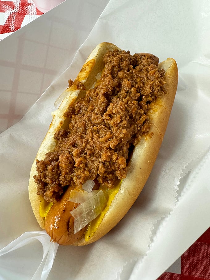 The humble hot dog elevated to art form. That generous blanket of chili isn't just a topping – it's a warm, spicy hug for your taste buds.