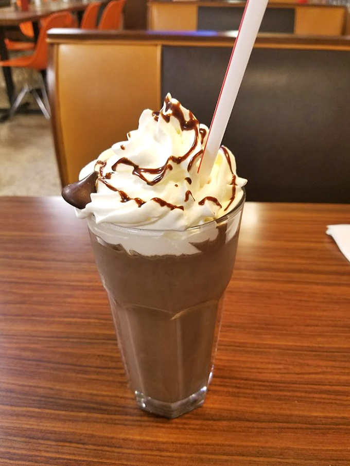 This chocolate shake topped with whipped cream isn't just dessert—it's what happiness would look like if it took liquid form.