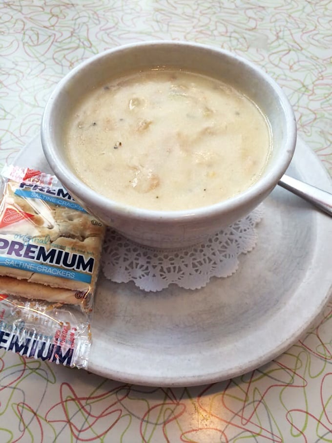 The legendary clam chowder arrives with saltines on a doily—creamy, substantial, and honest as a handwritten thank-you note.