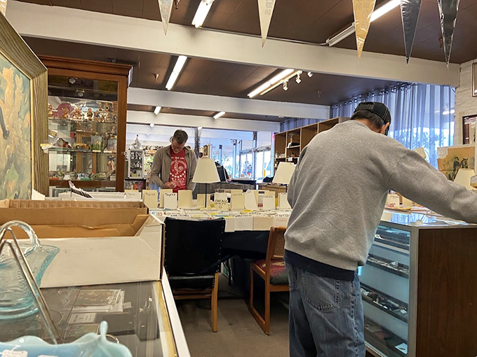 Treasure hunters in their natural habitat, carefully examining display cases. The thrill of the find keeps collectors coming back for more.