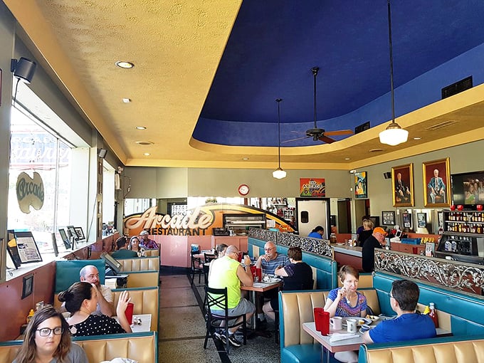 The blue ceiling and vintage booths create a diner universe where coffee is always hot and conversation flows easier than anywhere else.