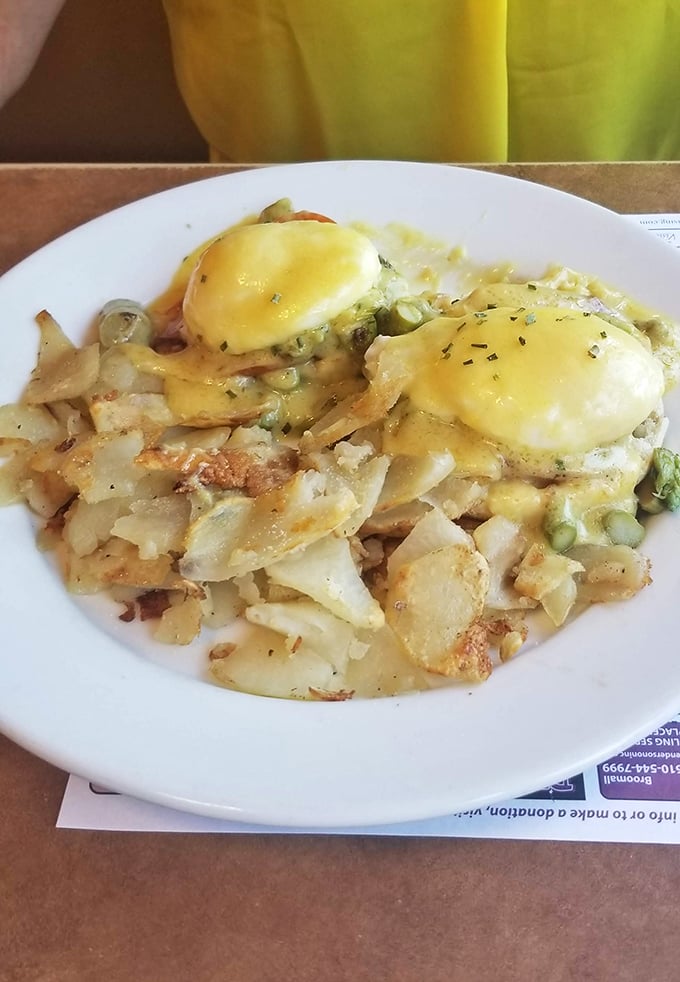 Eggs Benedict that puts hotel brunch buffets to shame. Those home fries have achieved the perfect crisp-to-fluffy ratio – the golden equation of diner physics.