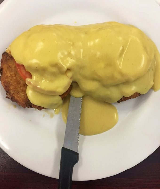 Eggs Benedict drowning in hollandaise isn't just breakfast—it's a commitment to starting your day with absolutely zero regrets.
