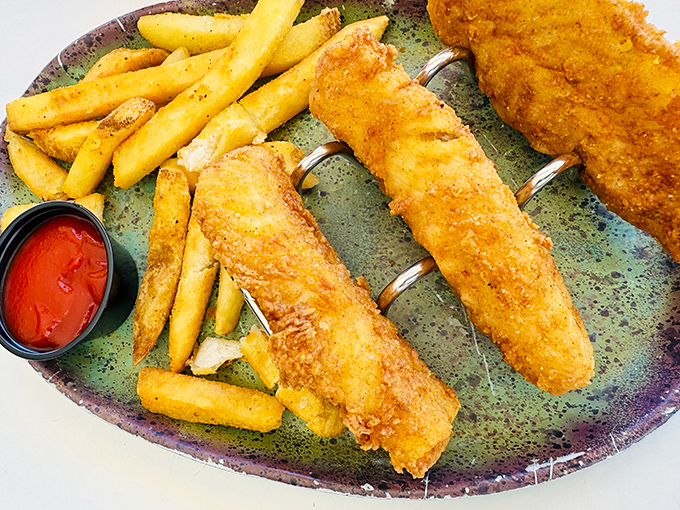 Fish and chips done right—golden, crispy perfection on the outside, flaky tenderness within, and fries that deserve their own fan club.