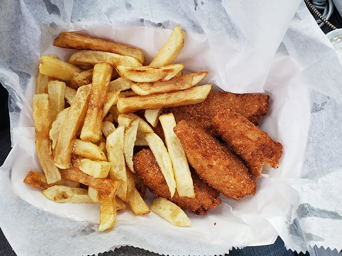 The fish and chips basket – where golden fries and perfectly breaded fish coexist in a harmony that would make any British pub jealous.