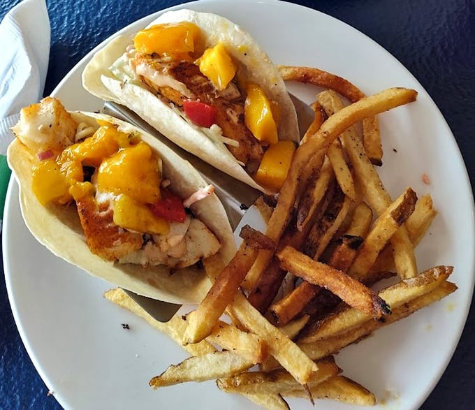 Fish tacos with mango salsa and hand-cut fries—proof that sometimes the simplest pleasures deliver the most profound satisfaction.
